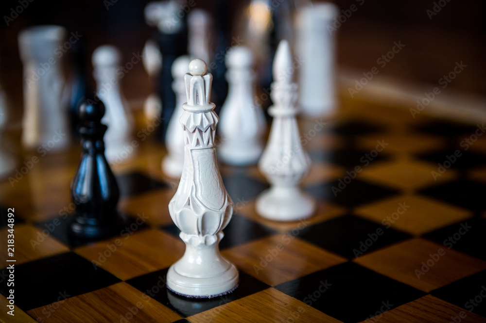 Chess pieces on a chessboard. Chess. Chess pieces on a blurry ...