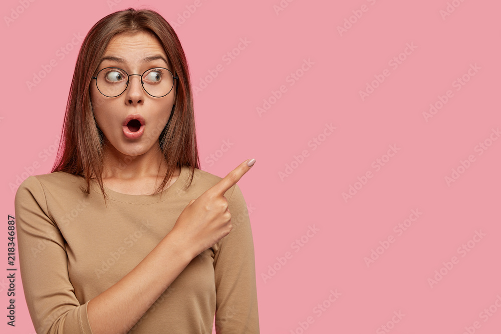 Surprised lovely young female being shocked by interesting unexpected ...