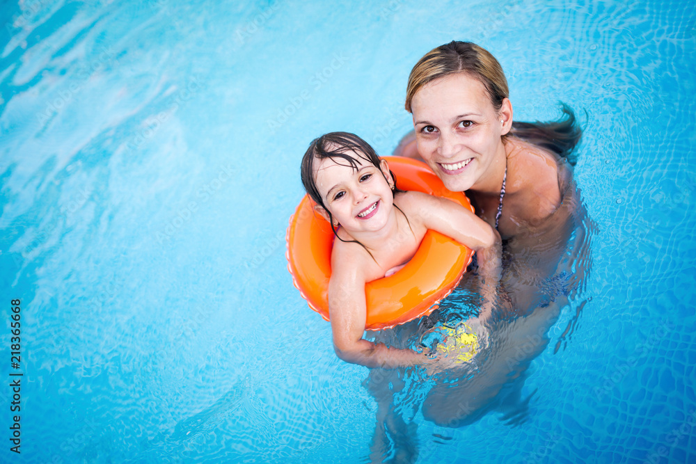 Beautiful woman with her daughter in swimming pool Stock Photo | Adobe ...