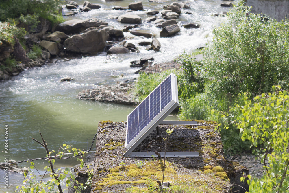 The solar cell unit on a mossy concrete slab above the turbulent ...