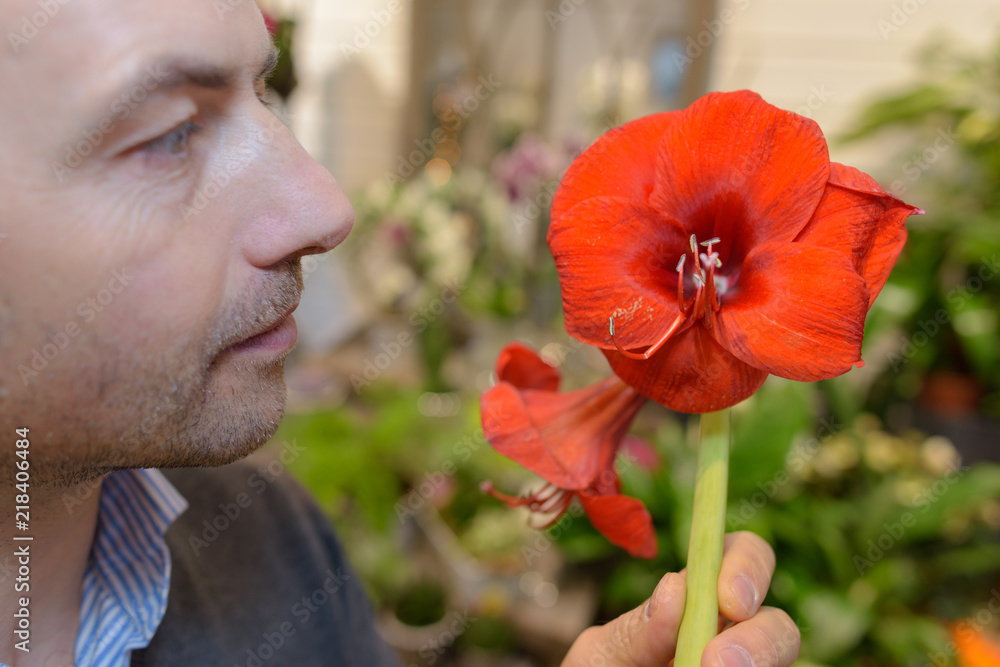 man holding a flower Stock Photo | Adobe Stock