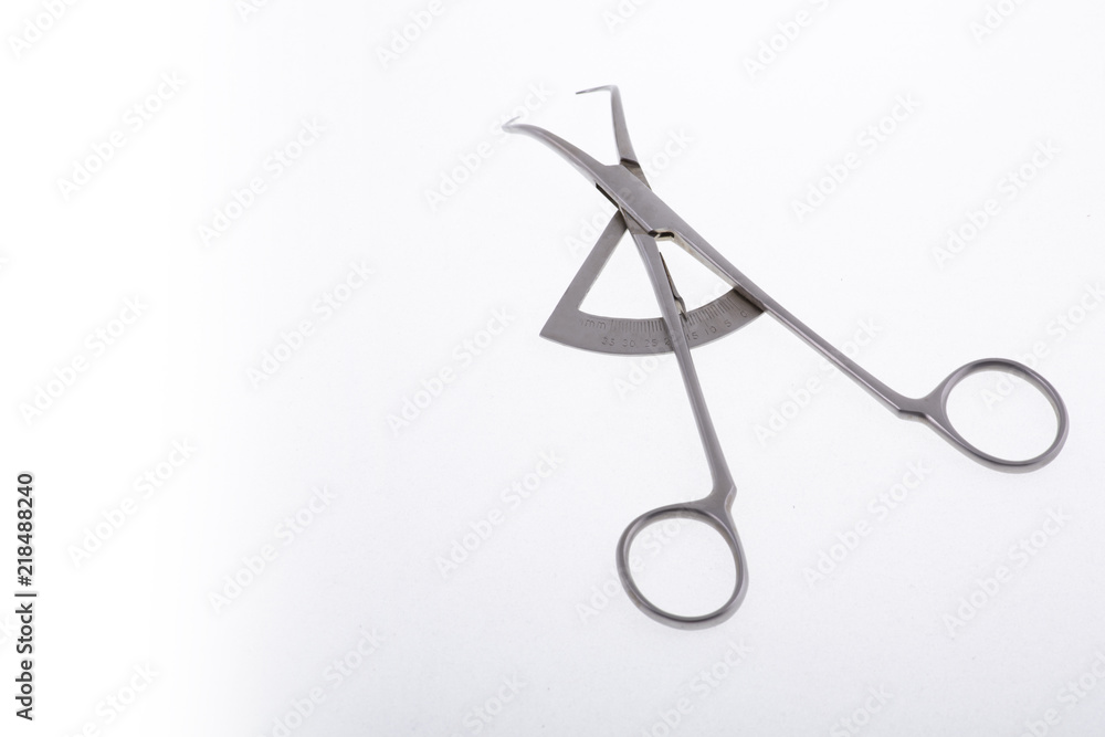Dental caliper on white background. This instrument has calibrated ...