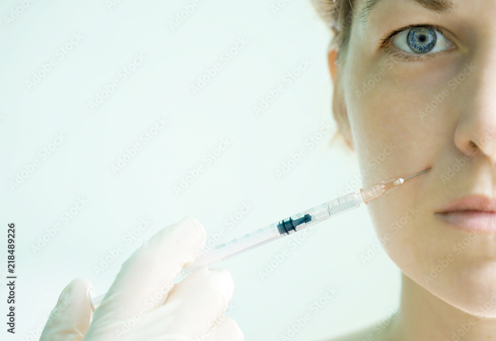 the girl with blue eyes doctor cosmetologist makes injections in the ...