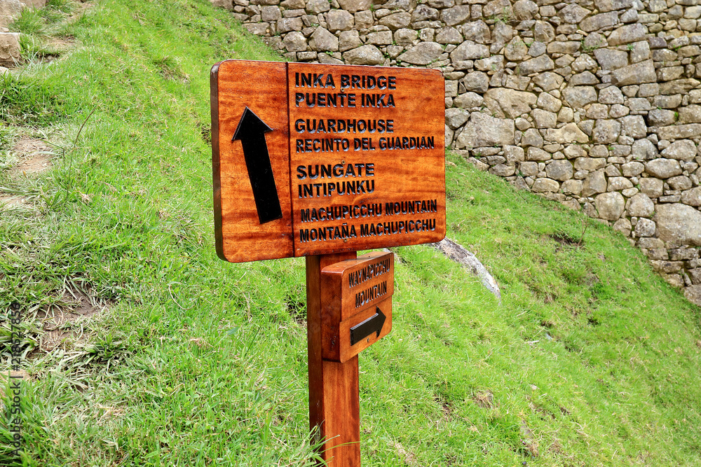Wooden signpost to the INKA BRIDGE, GUARDHOUSE, SUN GATE and ...