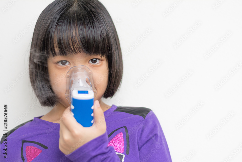 Beautiful sick girl inhalation therapy by the mask of inhaler . Close ...