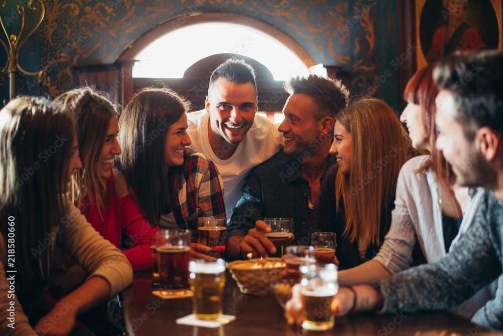 Group of teens having fun in a pub Stock-Foto | Adobe Stock