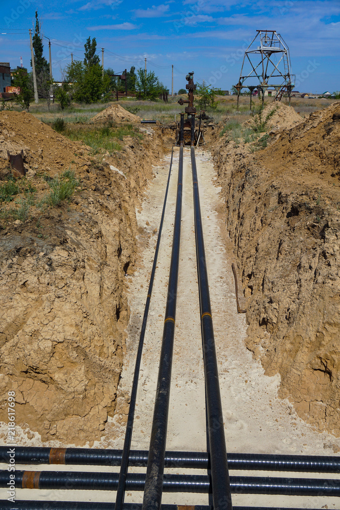 Oil pipelines DN150 in isolation at a turn in the trench comes to the ...