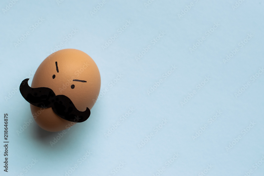Egg with mustache on light blue background for Movember concept which ...