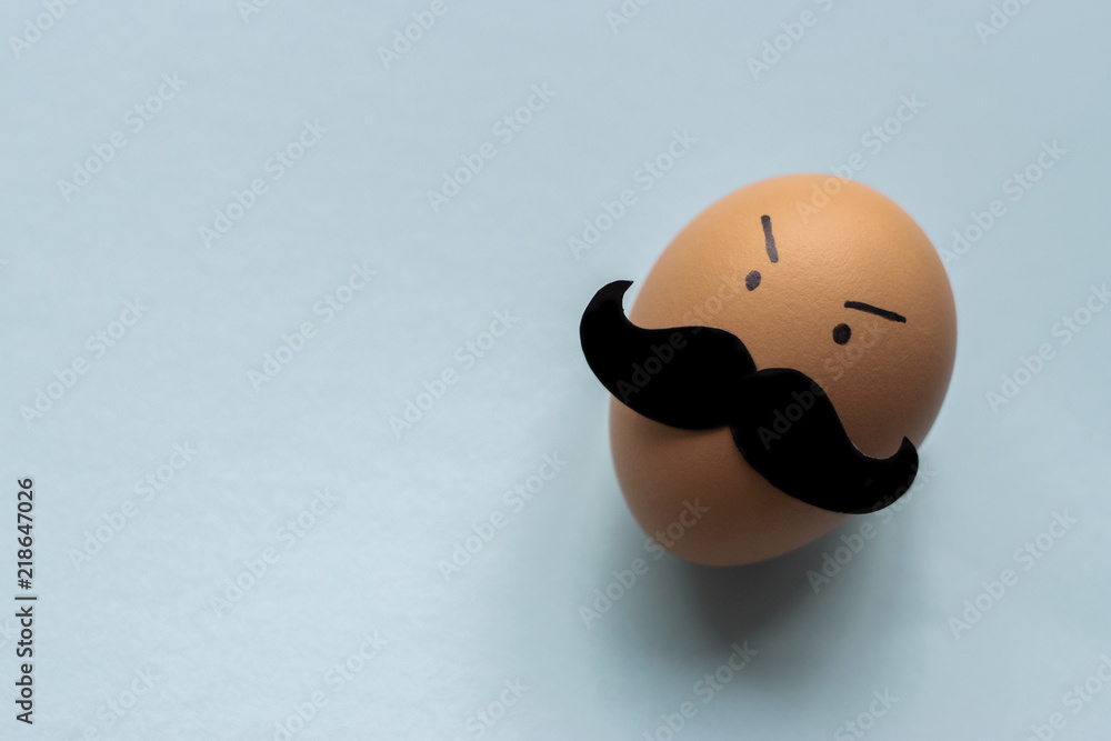 Egg with mustache on light blue background for Movember concept which ...