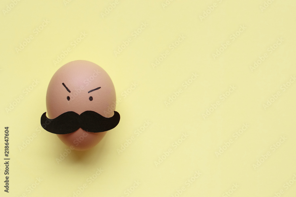 Egg with mustache on light yellow background for Movember concept which ...