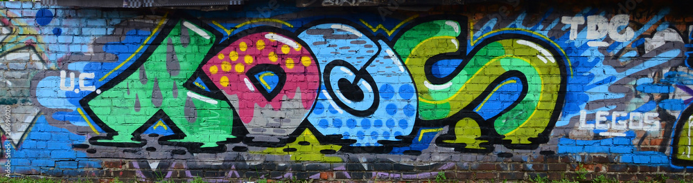 Full and acomplished graffiti artwork. The old wall decorated with ...