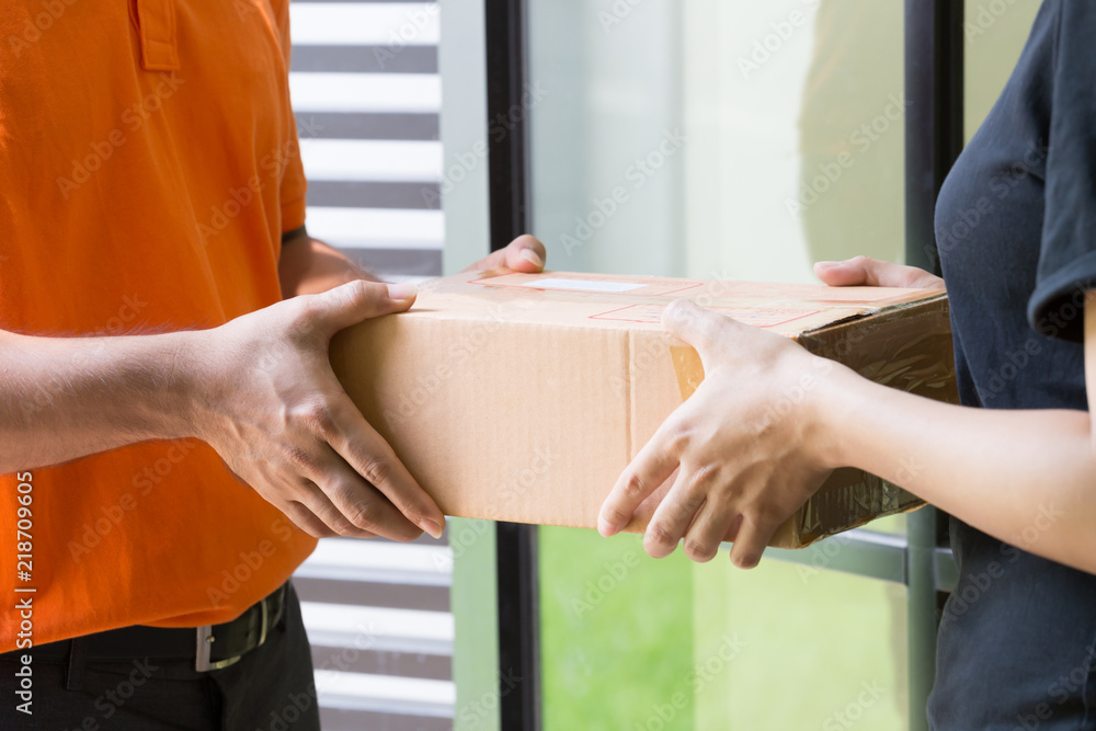 Woman customer accept and receive parcel from delivery man at front ...