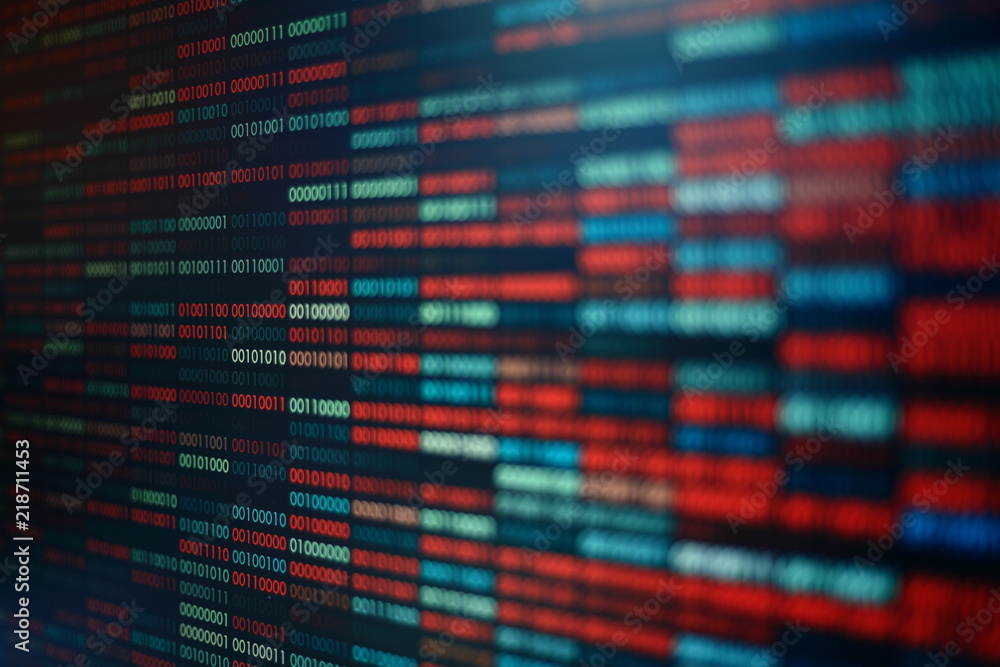 Computer virus infection. Row of binary codes randomly colored red and blue on black screen ...
