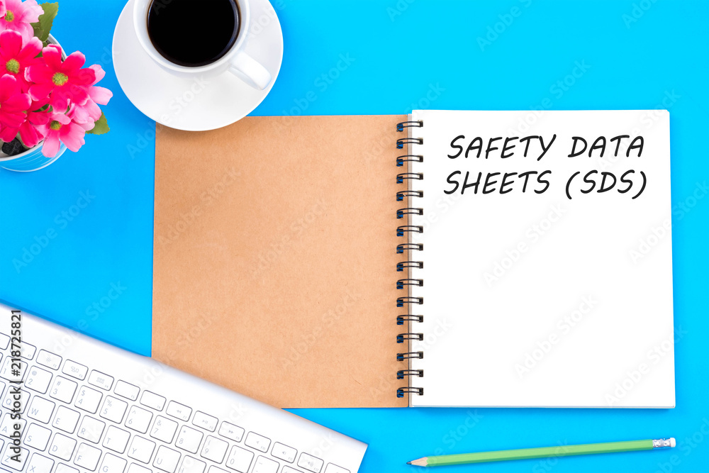 Concept SAFETY DATA SHEETS (SDS) message with modern workplace on blue ...