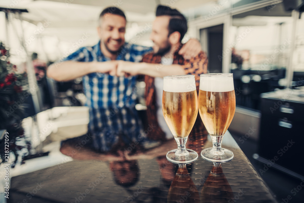 Special occasion. Close up of cold alcohol drinks with foam. Smiling ...