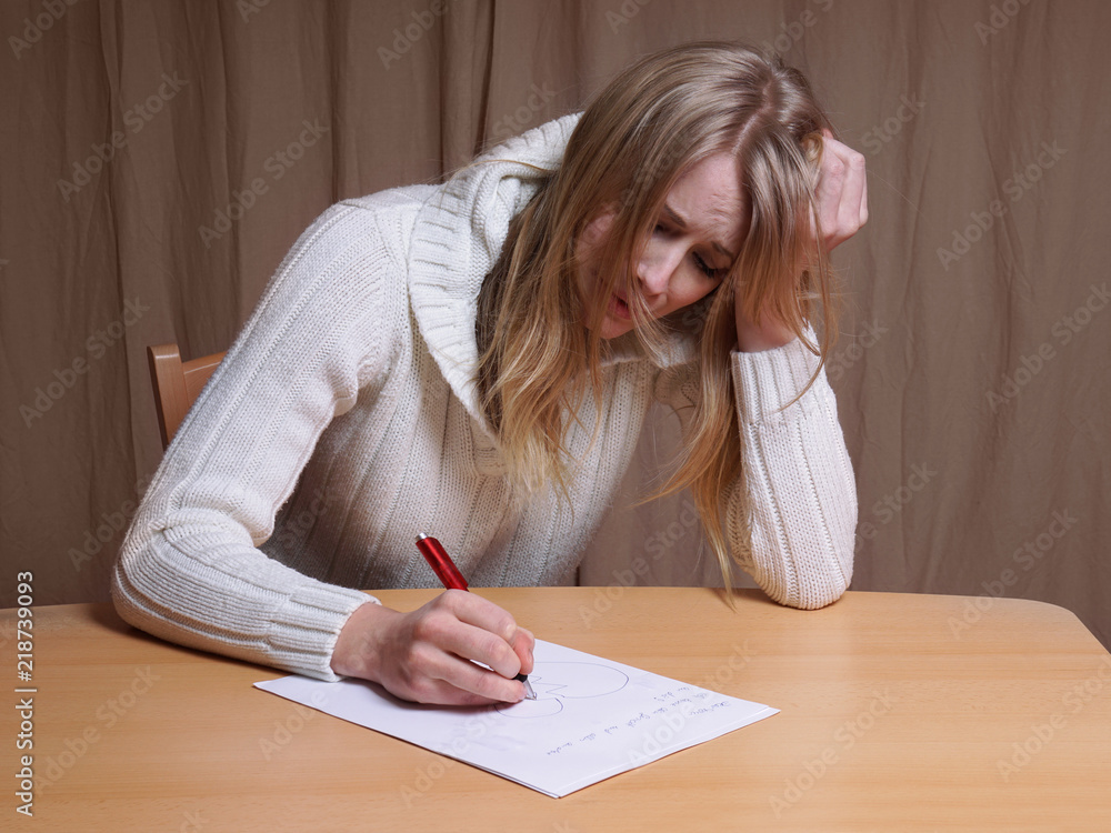 lovesick young woman writing letter with broken heart Stock Photo ...