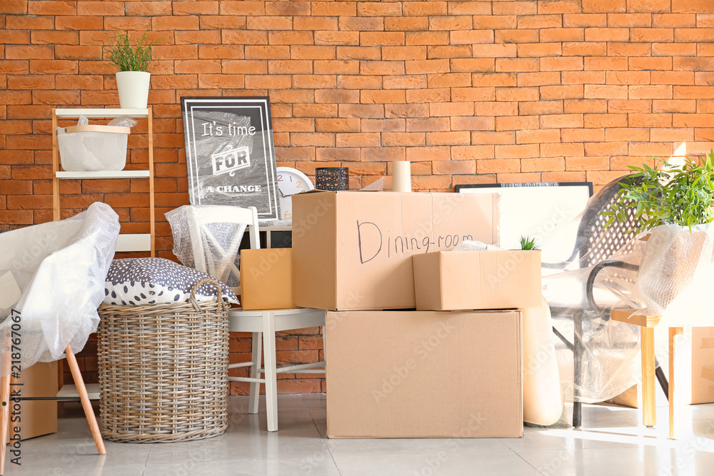 Carton boxes and interior items in room. Moving house concept Stock ...
