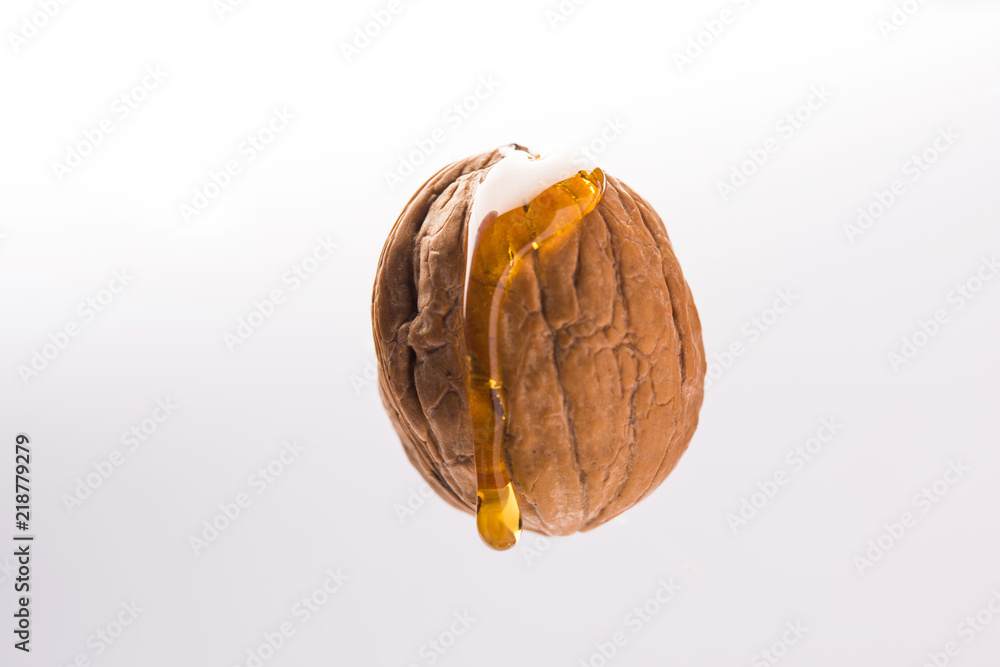 Golden walnut oil drop dripping fromnwhole Akrod/akhrot dry fruit ...