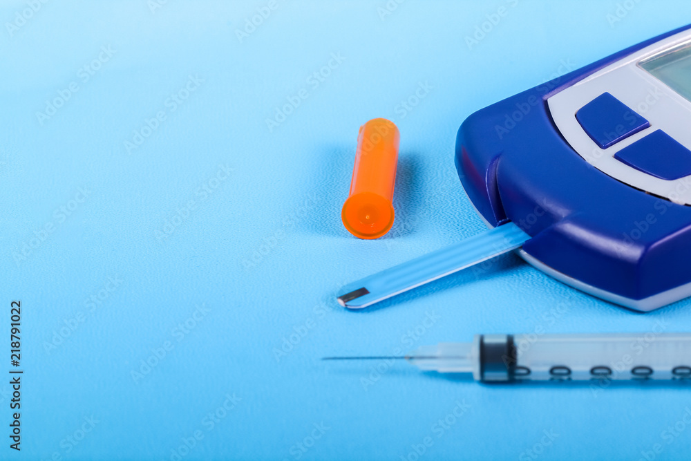 Insulin syringe injections and a glucometer for measuring blood sugar ...
