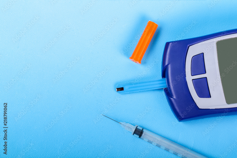 Insulin syringe injections and a glucometer for measuring blood sugar ...