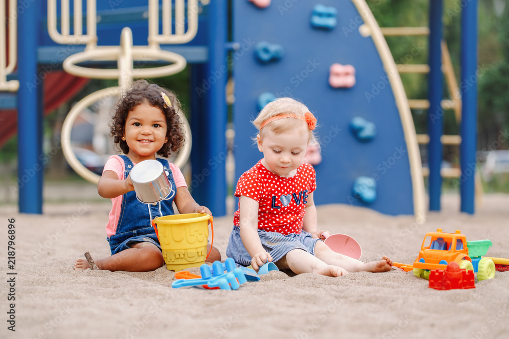 Happy childhood. Two cute Caucasian and hispanic latin babies children ...
