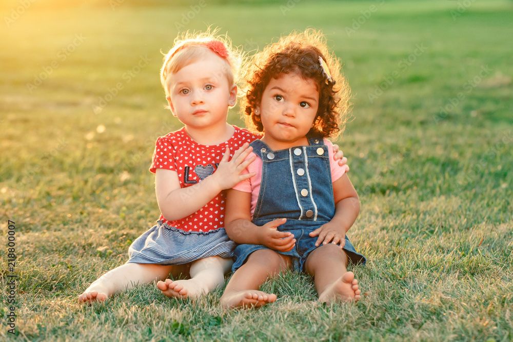 Group portrait of two cute adorable girls toddlers children sitting ...