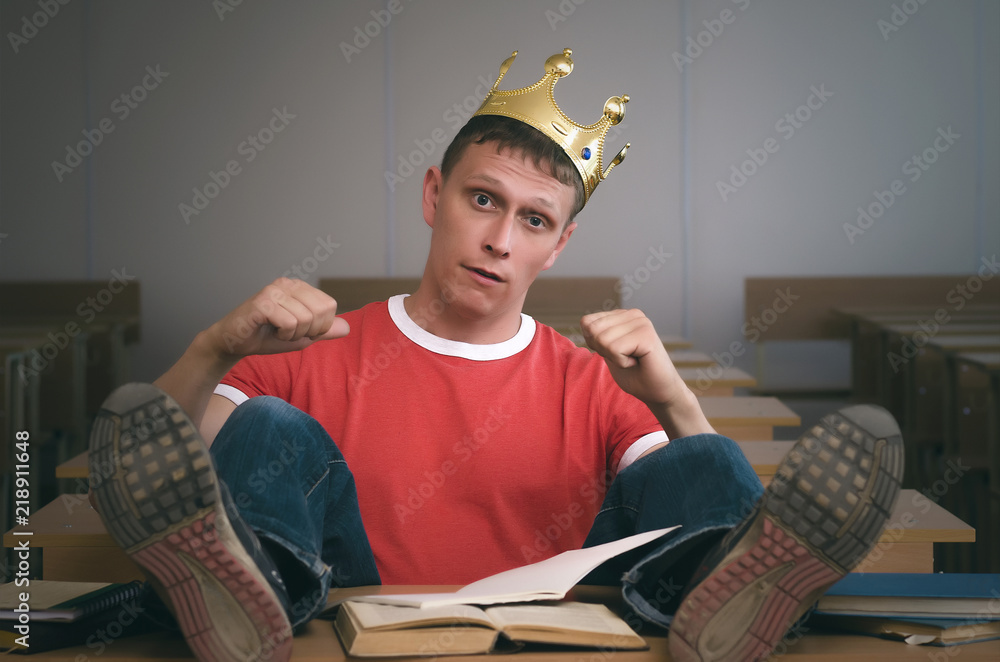 Arrogant student boy with golden crown above his head with an insolent ...