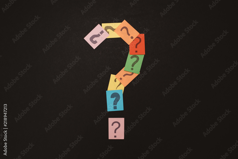 multicolored paper with QUESTION MARK isolated on black background ...