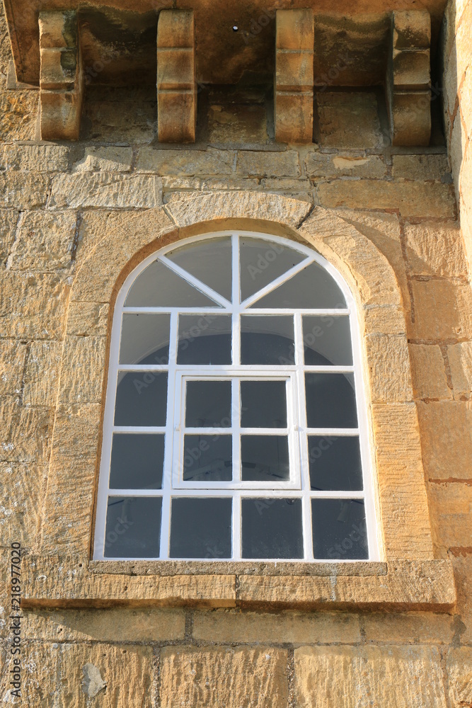 Round Georgian window from a tower in England. Round Georgian window in ...