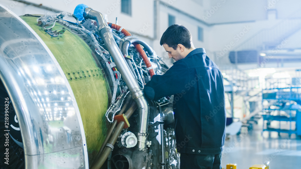 Aircraft Maintenance Mechanic Inspecting and Working on Airplane Jet ...