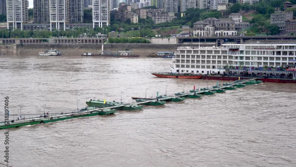 Side view of pontoon bridge across water to tourist cruise boat ...