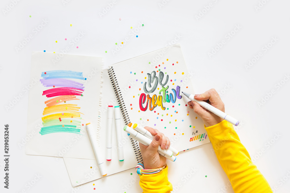 The girl writes letters with markers. Lettering. White background ...