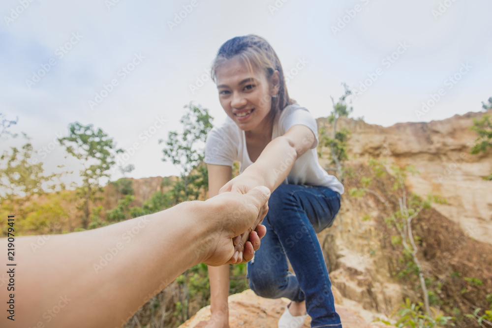 People helping each other hike up a mountain, Giving a helping hand ...