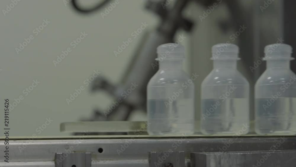 Sterilized clogged plastic bottles with medicine on the conveyor of ...