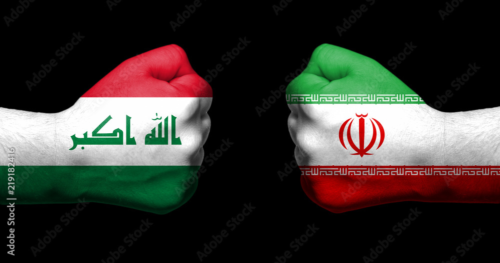 Flags of Iraq and Iran painted on two clenched fists facing each other ...