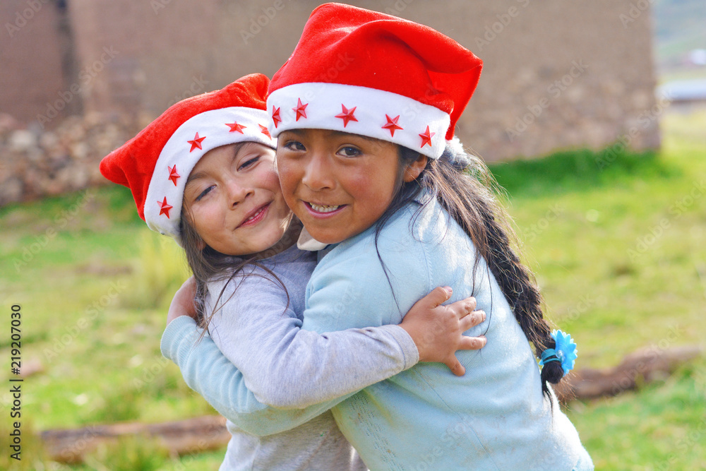 Happy little native american sisters hugging outdoors. Children wear ...
