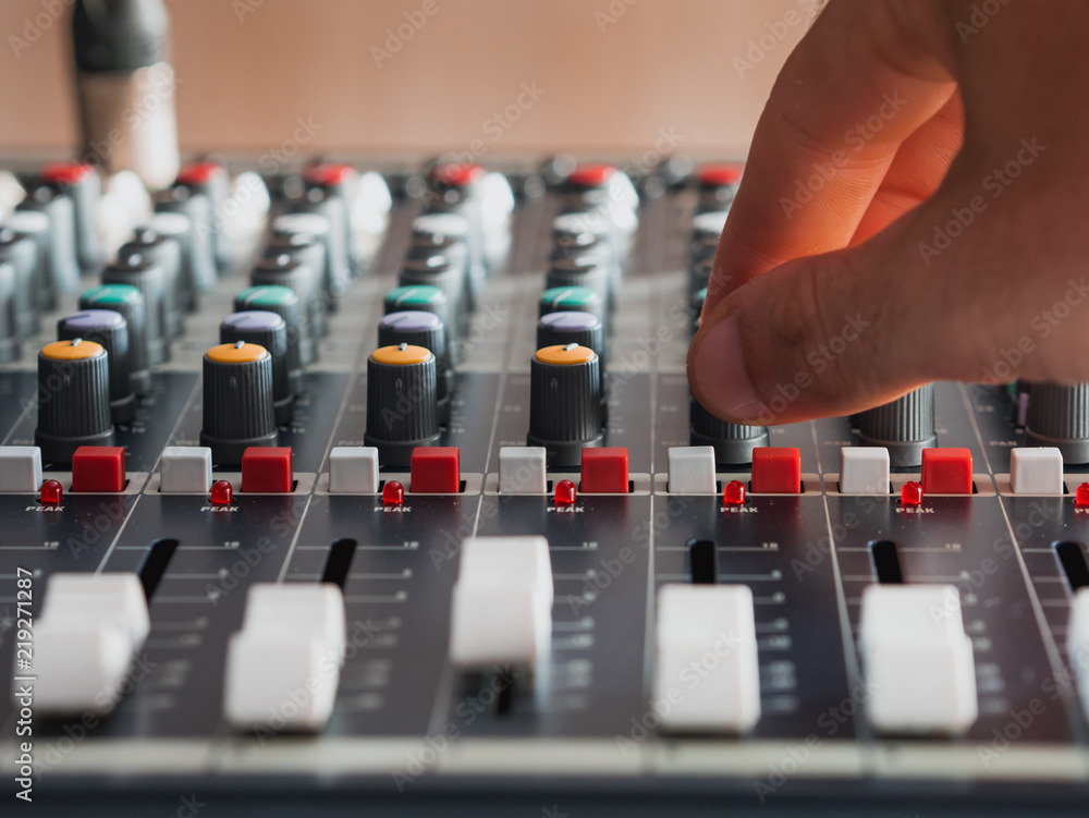Adjusting buttons on audio mixer Stock Photo | Adobe Stock