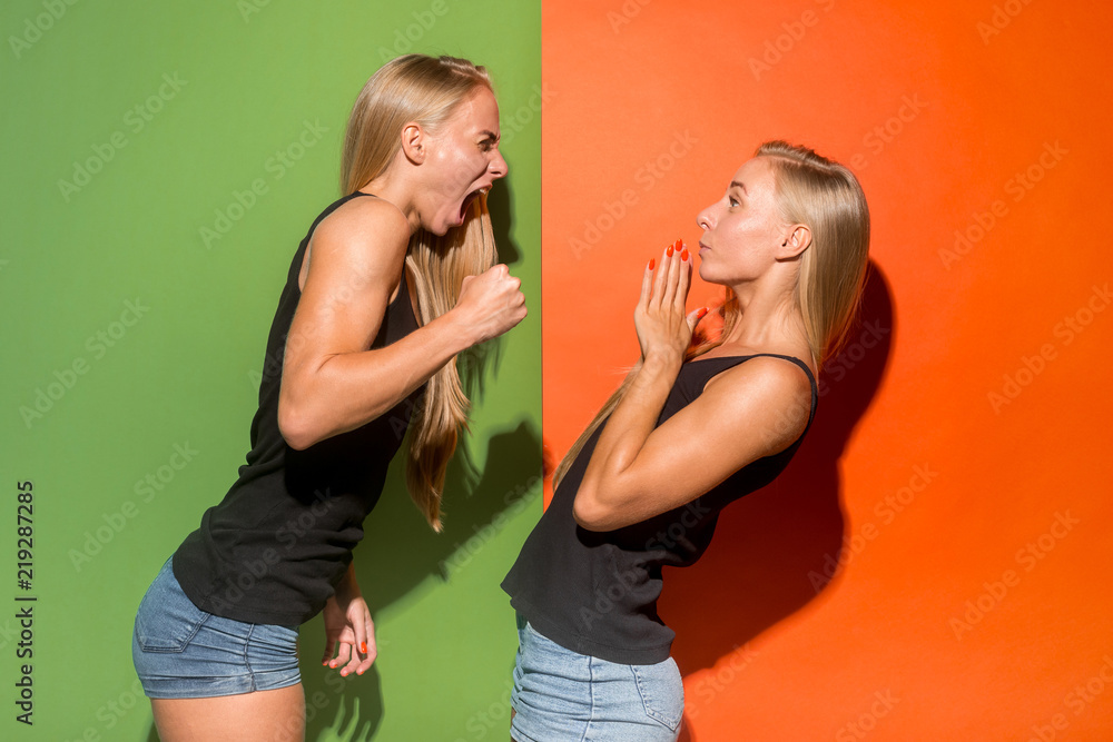 Angry women. Aggressive women standing isolated on trendy studio ...