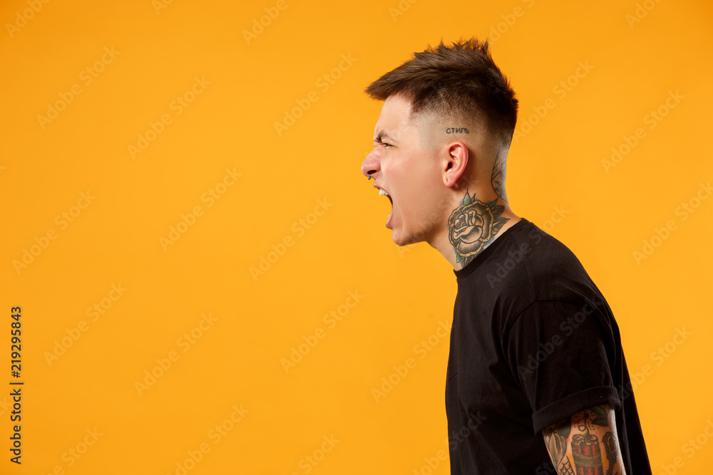 Screaming, hate, rage. Crying emotional angry man screaming on studio ...