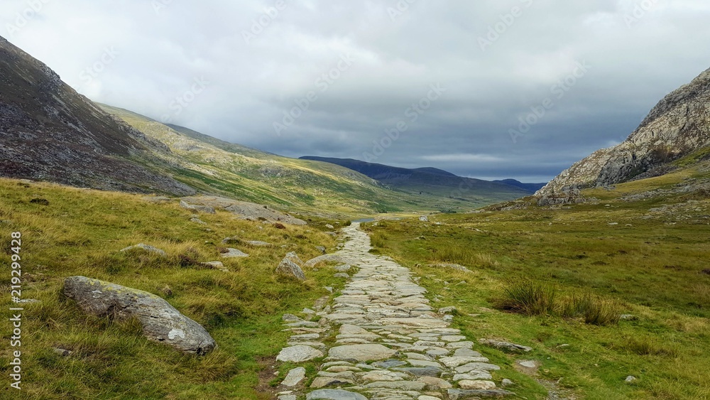 Ancient stone path through a beautiful rugged landscape in Wales ...