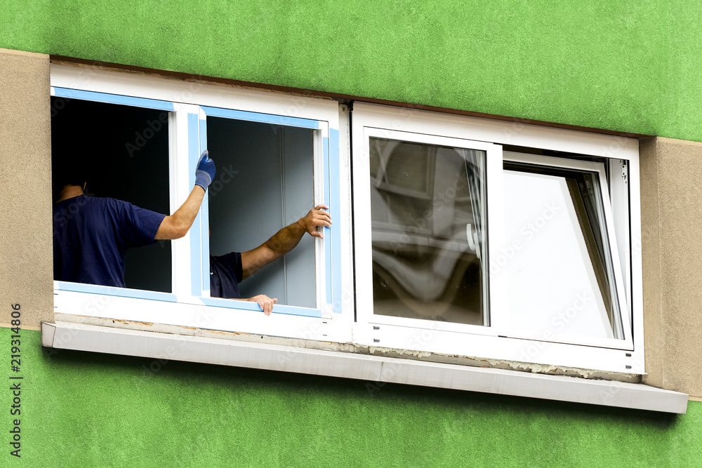 construction workers replacing and installing window Stock Photo ...