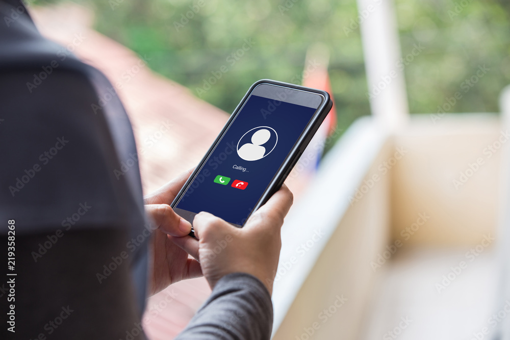 Voice call concept on the screen. Woman hand holding smartphone doing ...