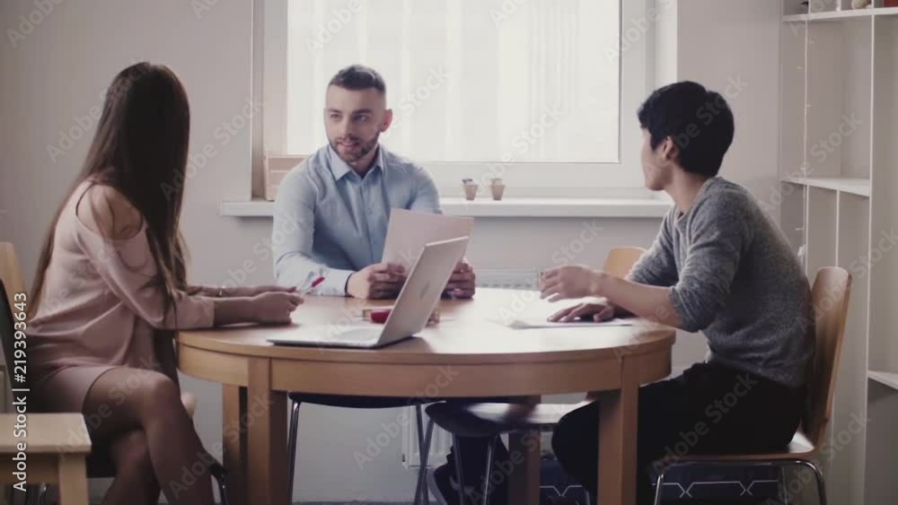 Beautiful Woman Boss Listening To Young Japanese Man At Job Interview