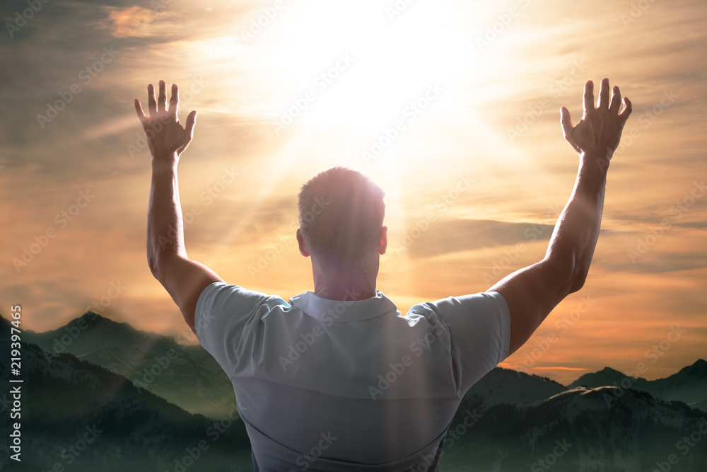 Man Raising His Arm At Sunset Stock Photo | Adobe Stock
