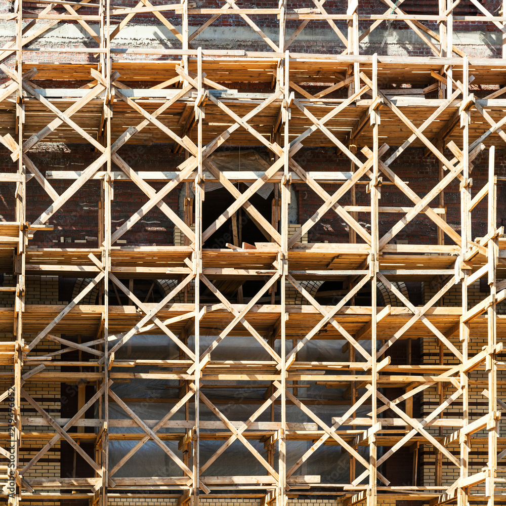 wooden scaffolding on multi-storey building Stock Photo | Adobe Stock