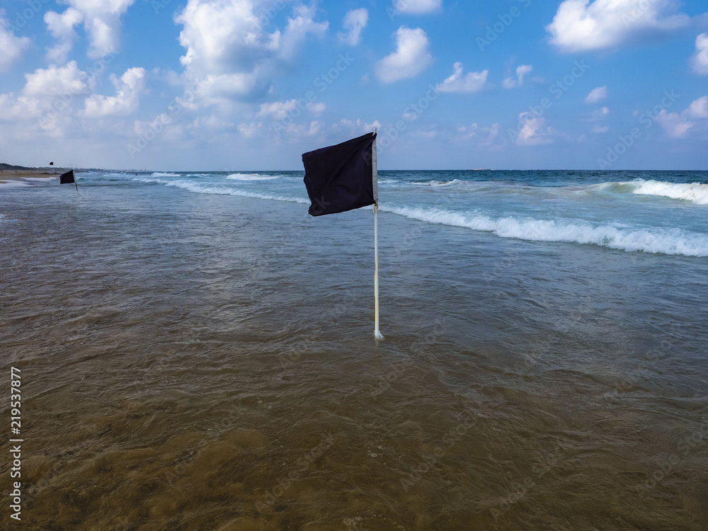 Black Flag on the sea shore-warning about dangerous current and waves ...