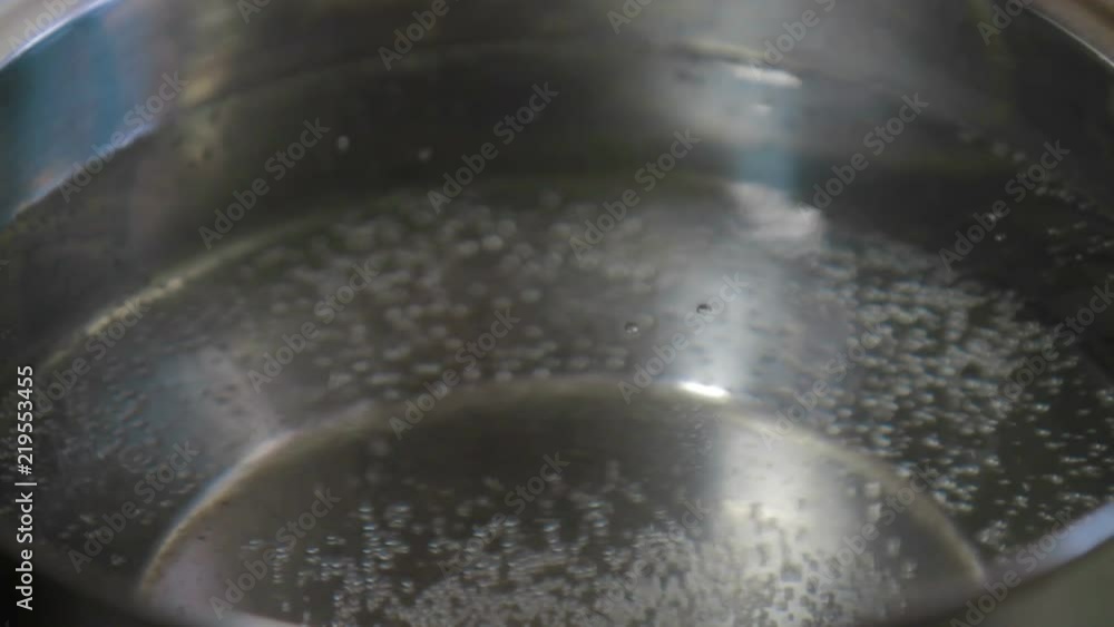 Boiling water in a kitchen pot Stock Video | Adobe Stock
