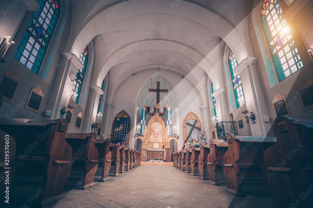 Roman Catholic church, rays of light through the stained glass of ...