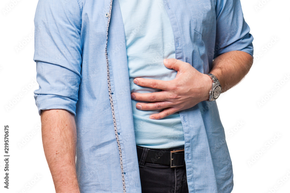A man holds his hand to the stomach from pain or hunger or overeating ...