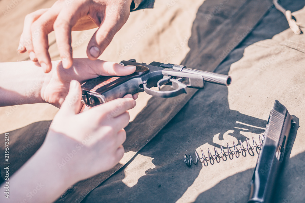 The father teaches his son to disassemble, clean and assemble the ...